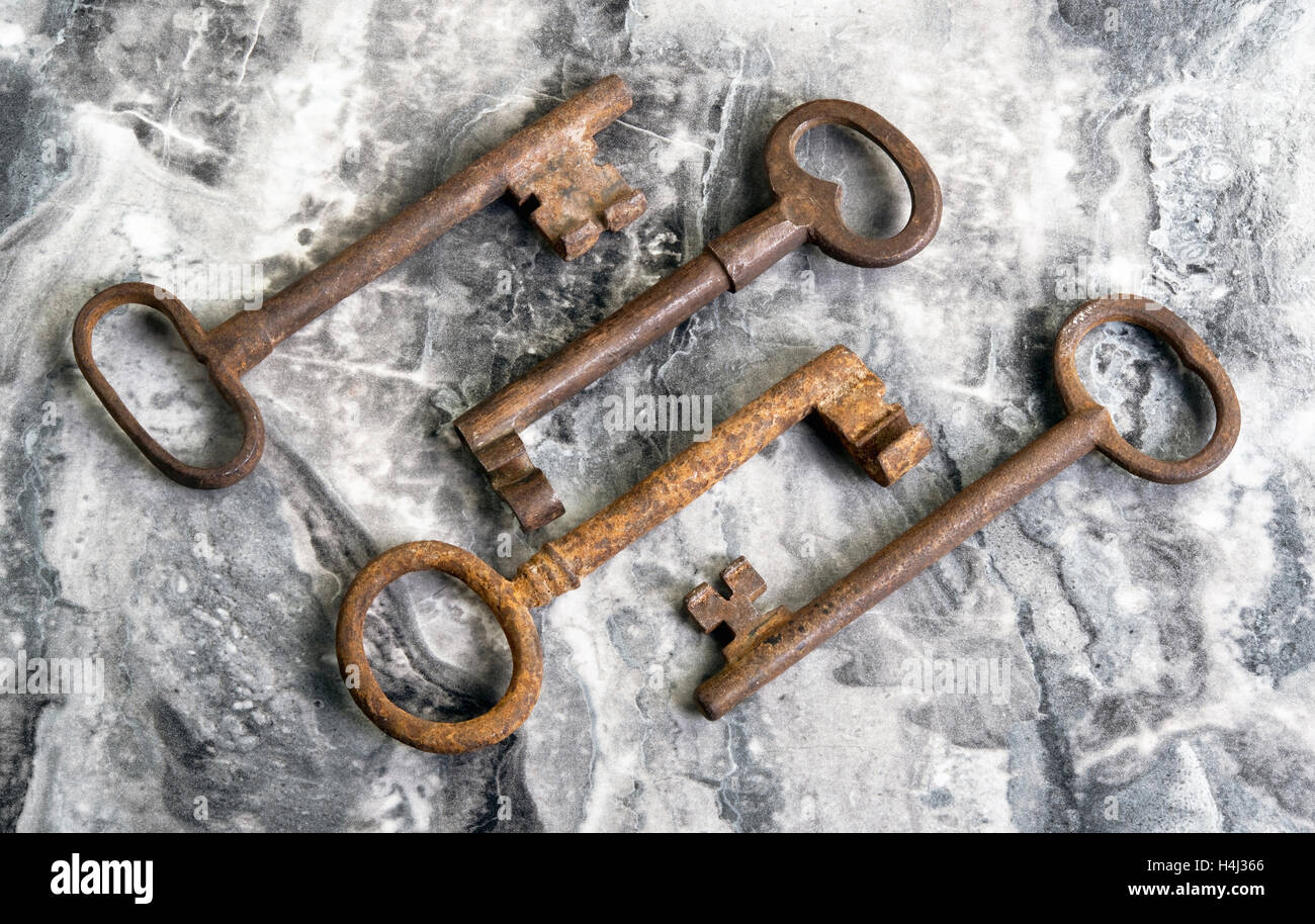Antique iron skeleton keys on marble table Stock Photo - Alamy