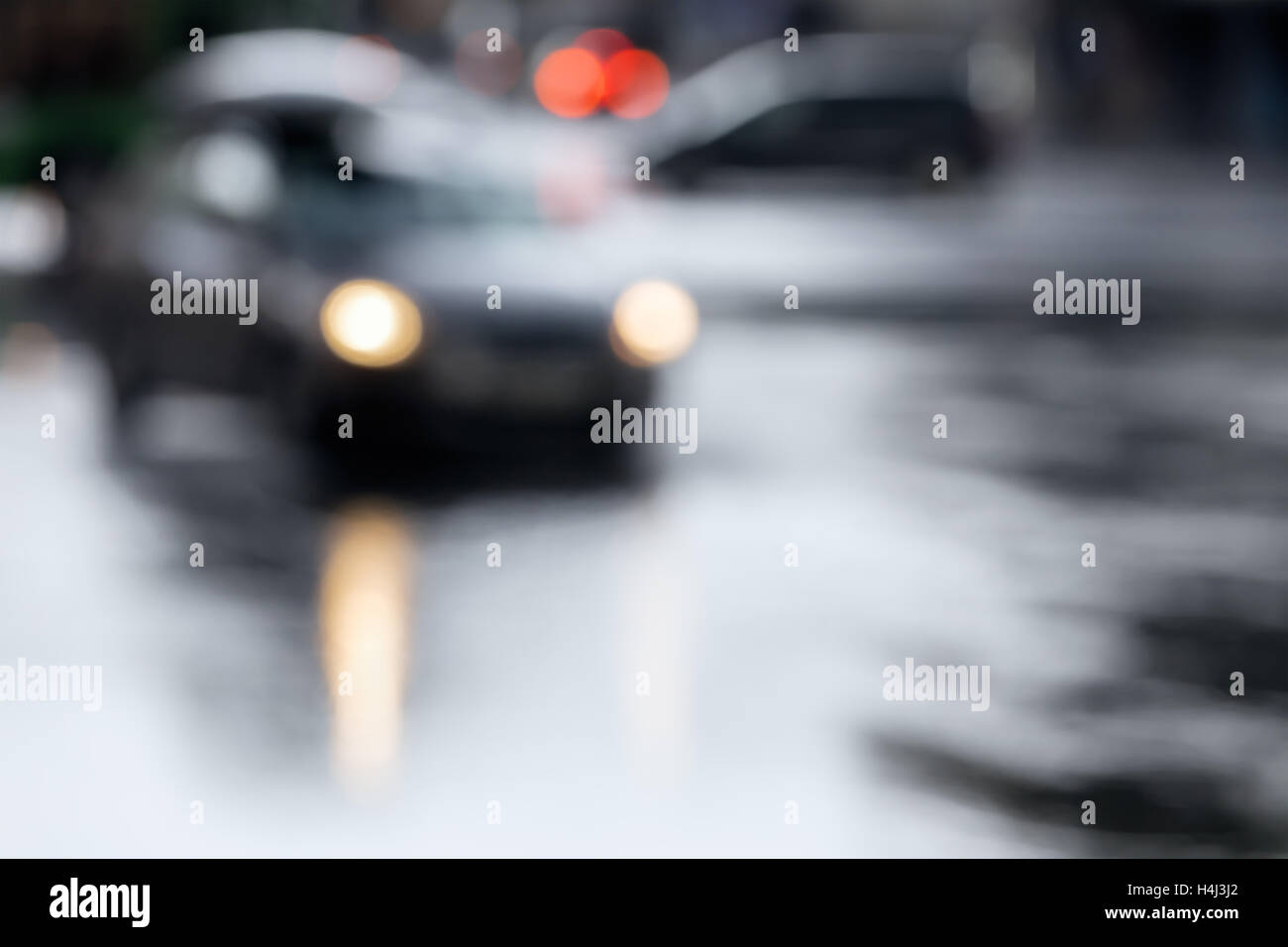 street road with cars during rain. blurred view through car windscreen ...