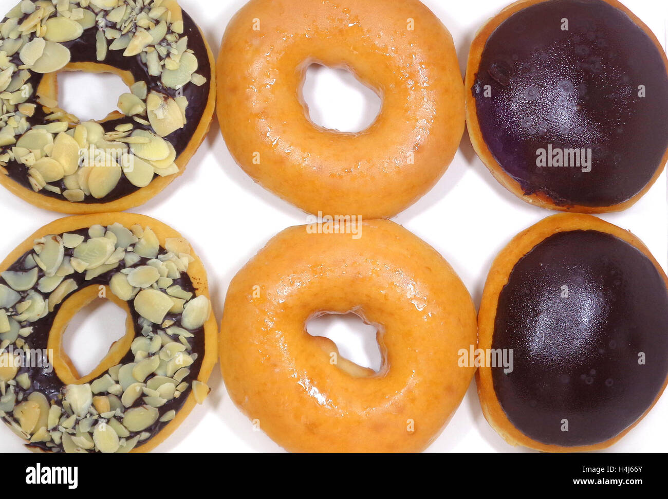 Six doughnuts in three types on white background Stock Photo - Alamy