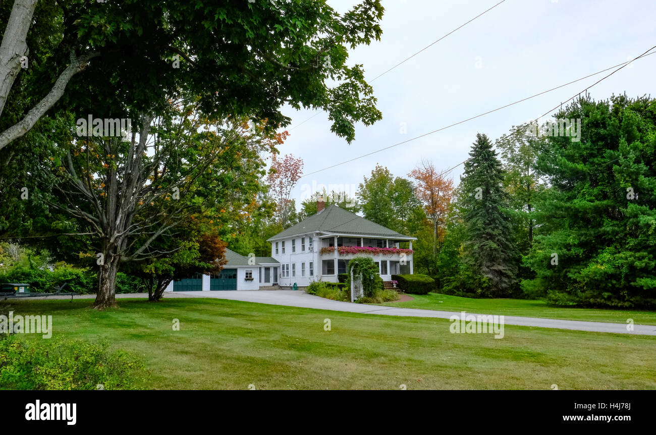 Large, colonial residential property with a newly cut lawn seen in ...