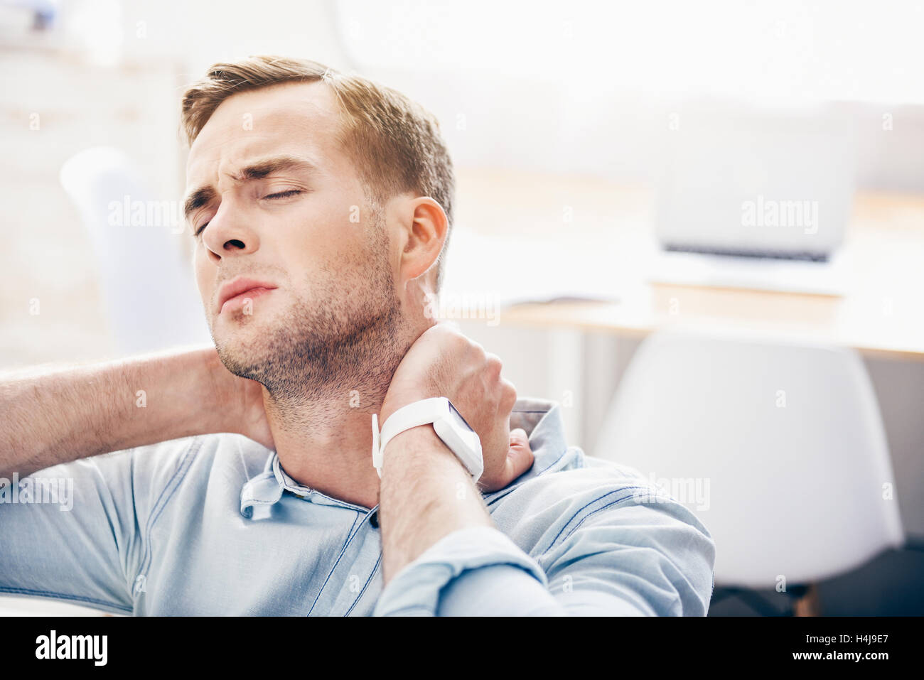 Cheerless man sitting on the couch Stock Photo - Alamy