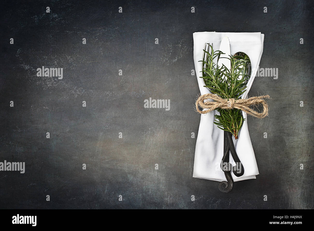 Antique silverware spoon and fork over a rustic grunge background ...