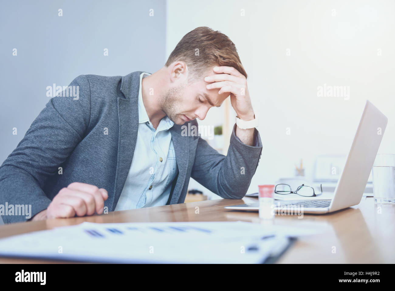 Hardworking young man working on laptop Stock Photo - Alamy