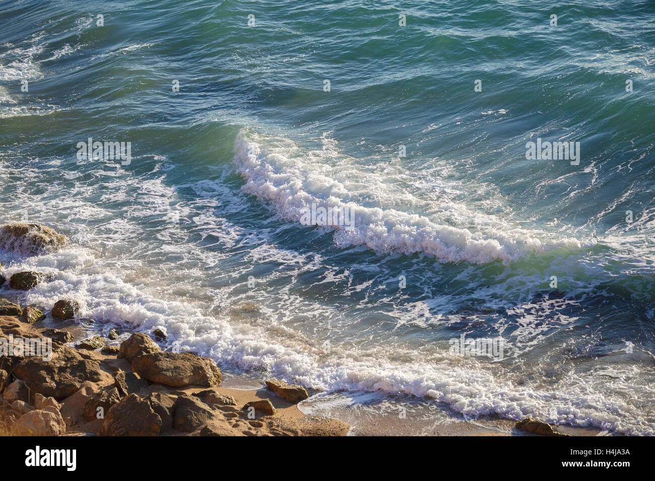 Beautiful marine nature on sunny day, waves and stones Stock Photo - Alamy