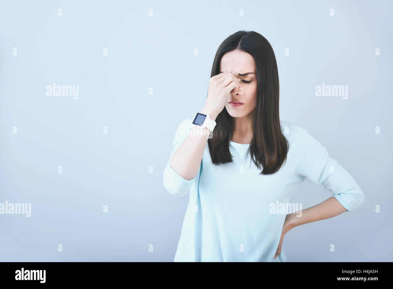 Pretty exhausted woman feelling tired against isolated white background ...