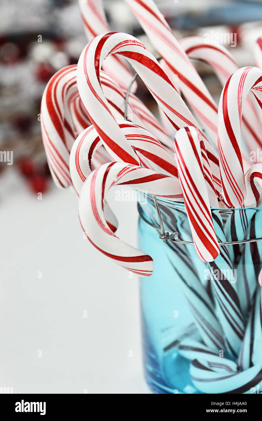 Candy canes in a pretty glass blue Container. Extreme shallow depth of ...
