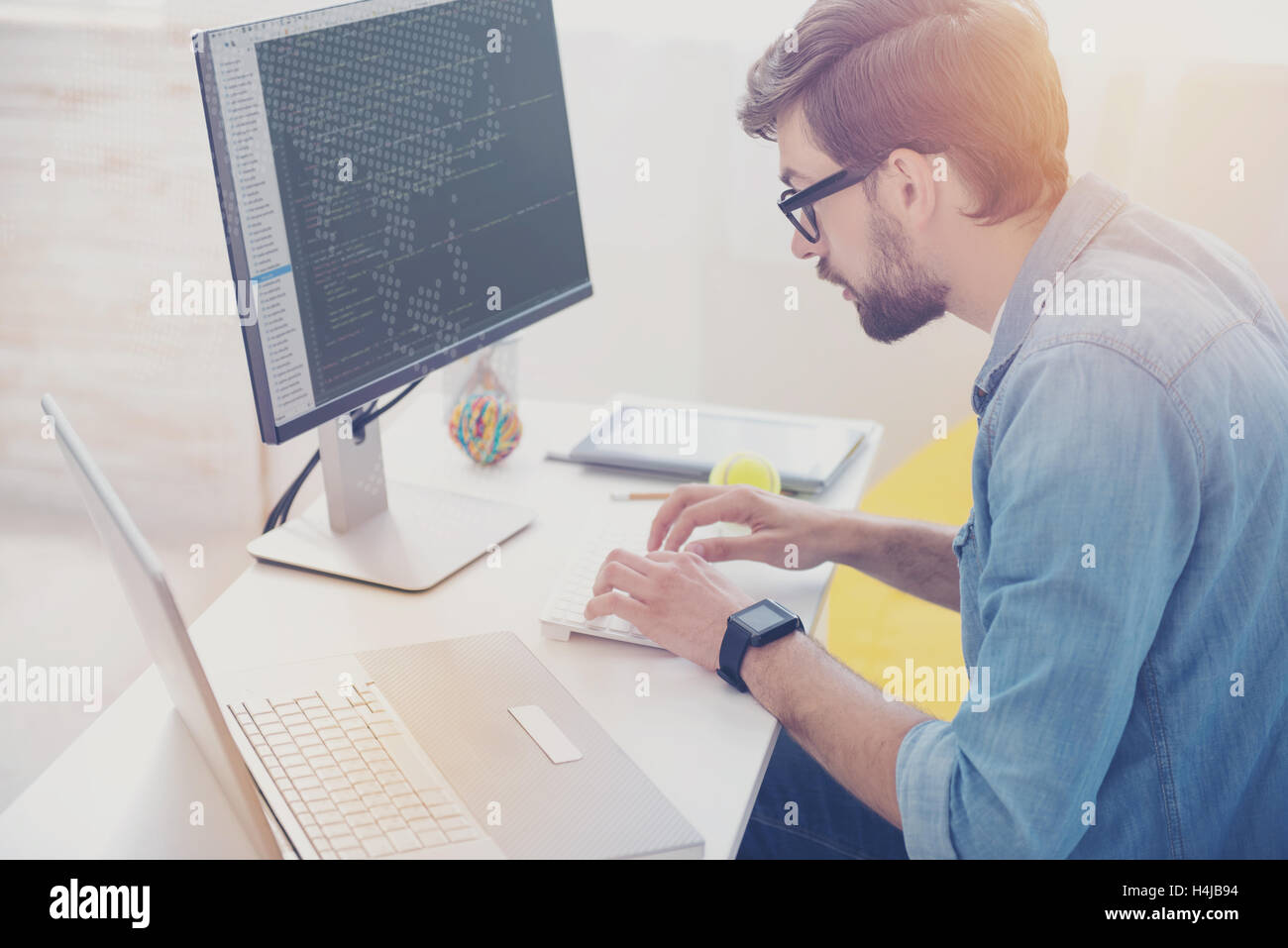 Enthusiastic programmer doing his work Stock Photo - Alamy