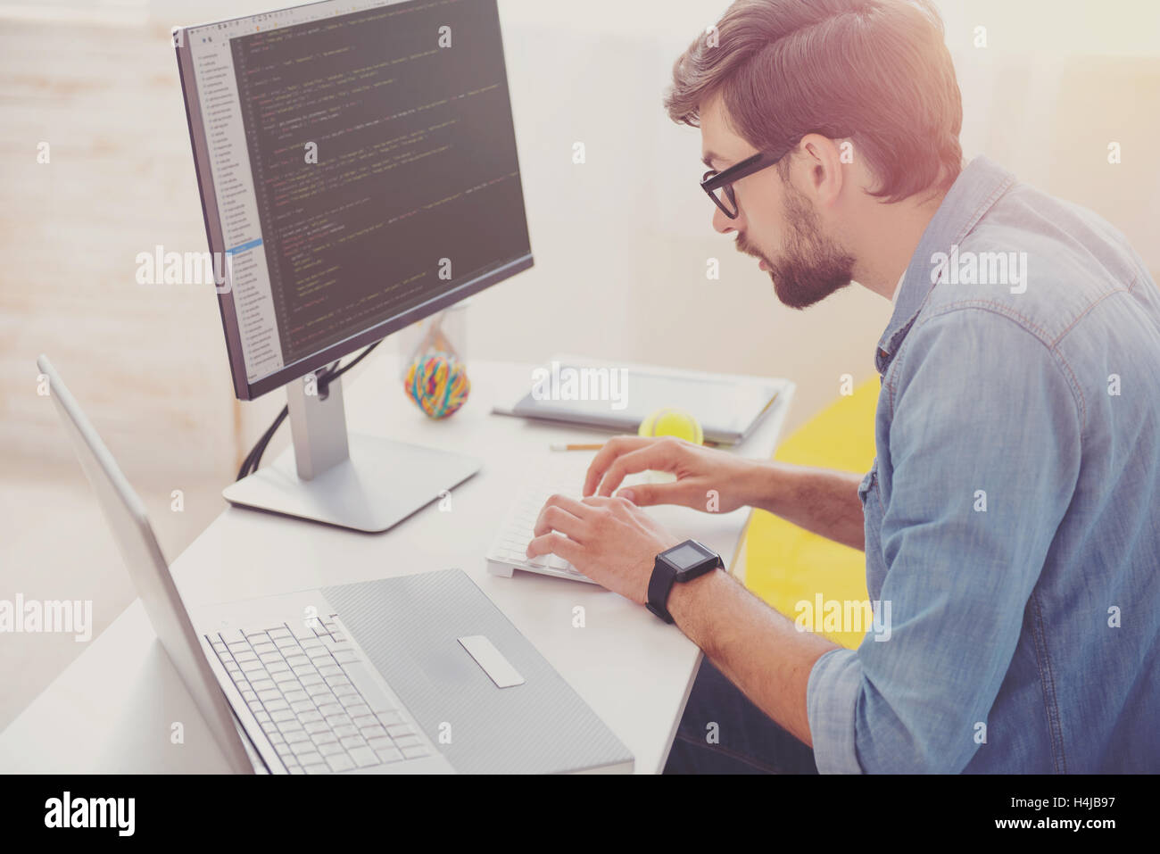 Concentrated programmer coding in an office Stock Photo - Alamy