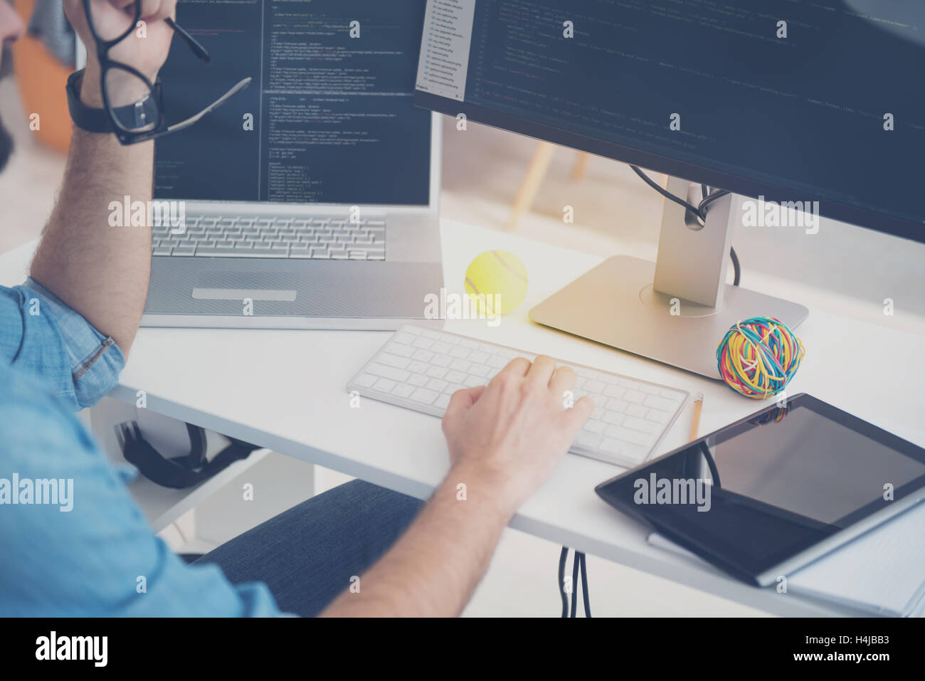 Concentrated on work man coding in an office Stock Photo - Alamy