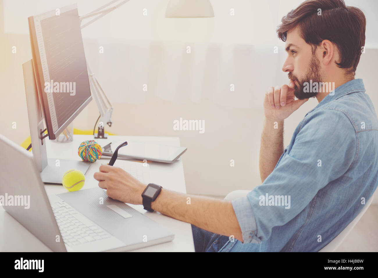 Handsome programmer analyzing his work Stock Photo - Alamy