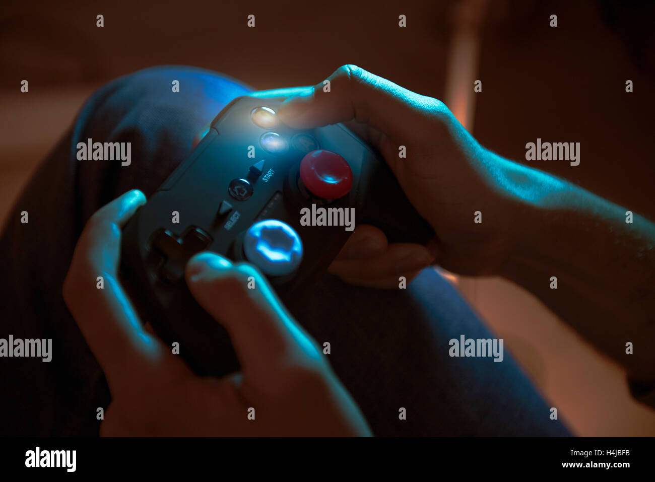 Young man holding playing console in his hands Stock Photo - Alamy