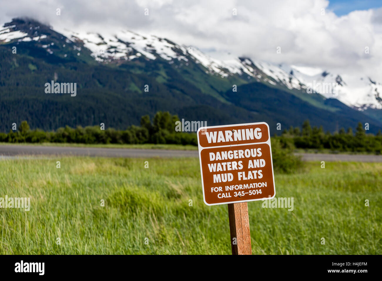 Sign for Dangerous Waters and Mud Flats in Alaska Stock Photo - Alamy