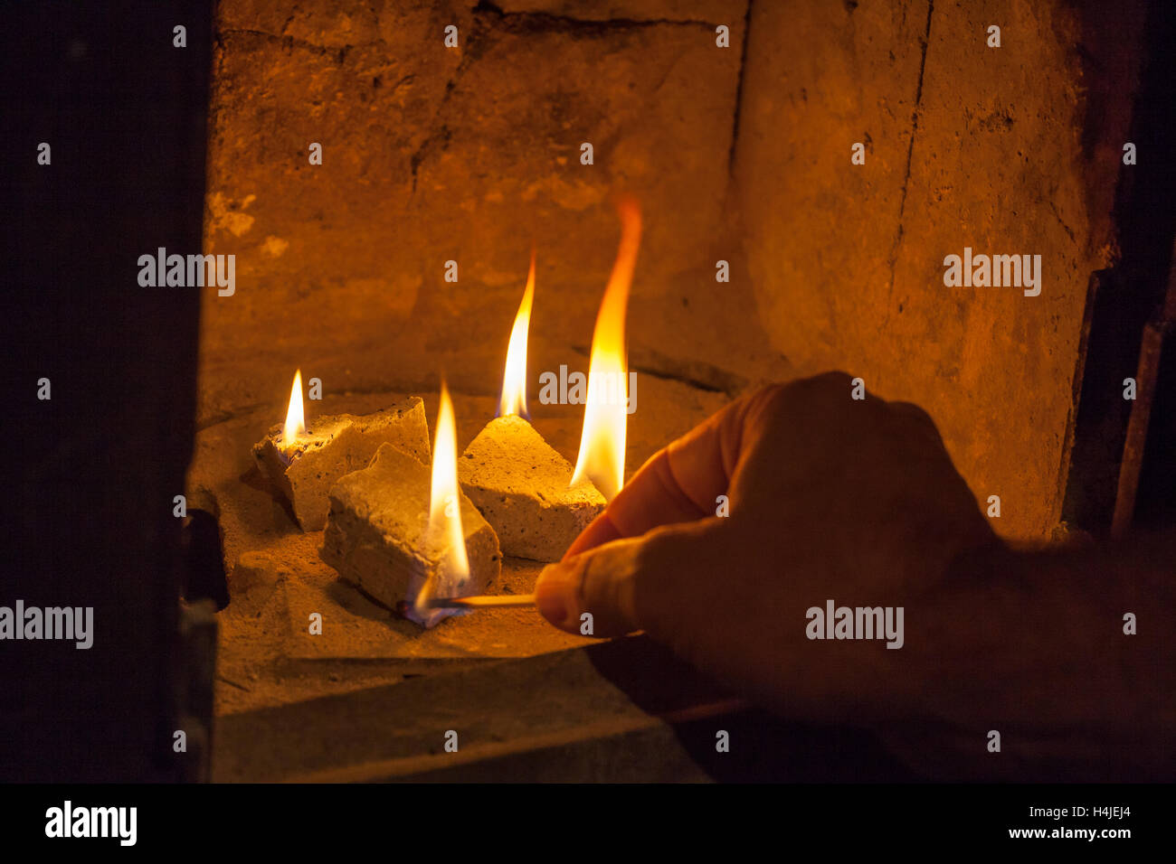 Lighting a wood burner Stock Photo - Alamy