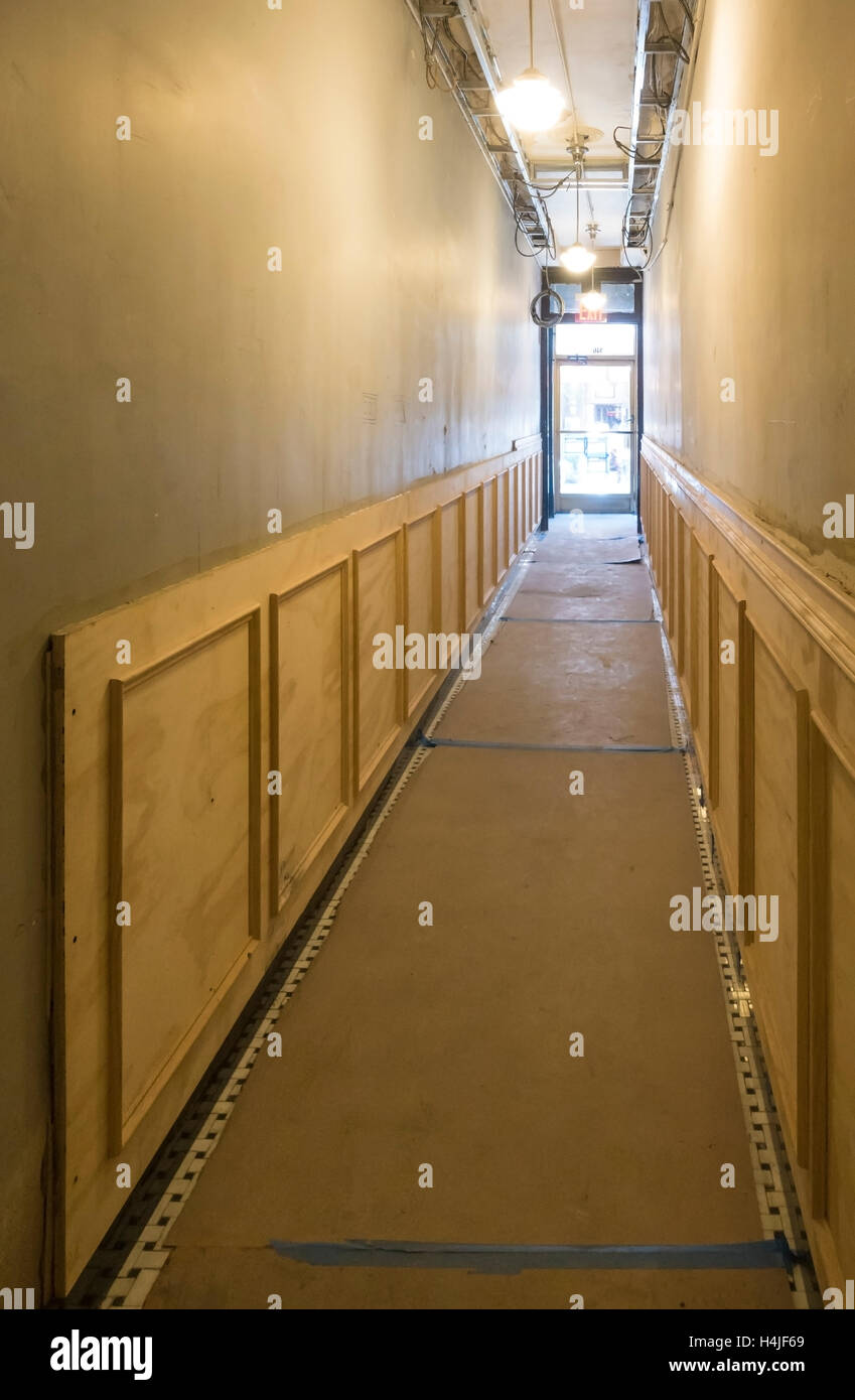 Work being done in the hall of a tenement building in Lower Manhattan ...