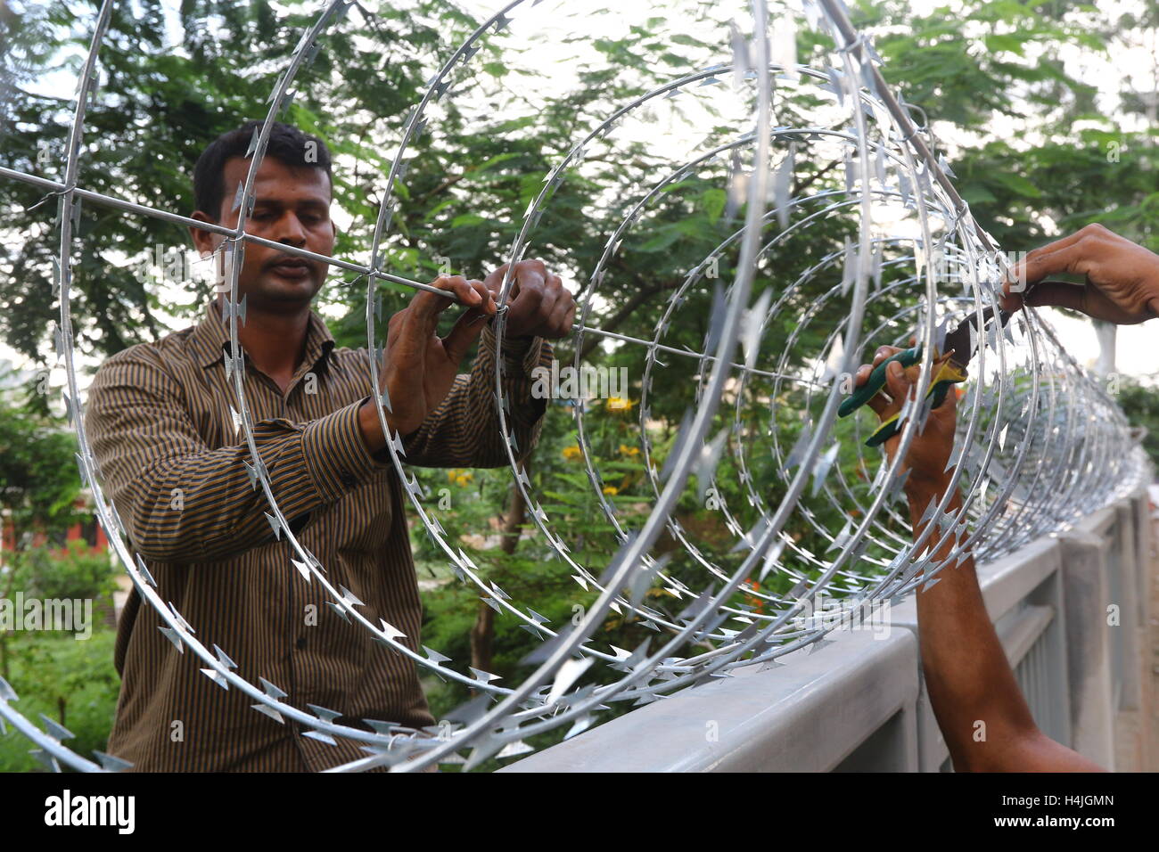 Being secured with razor wire on top of the iron fence in the capital ...