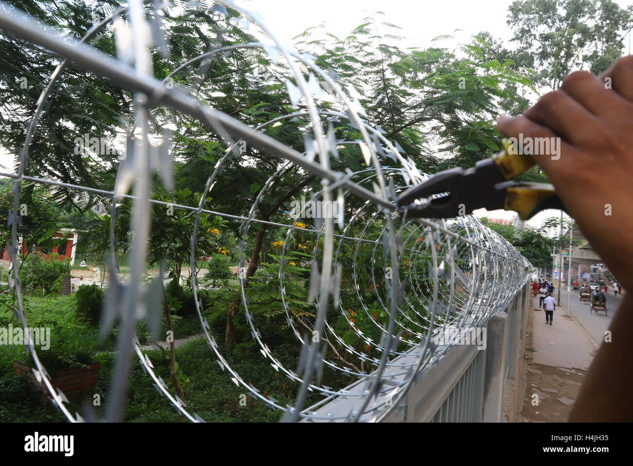 Being secured with razor wire on top of the iron fence in the capital ...