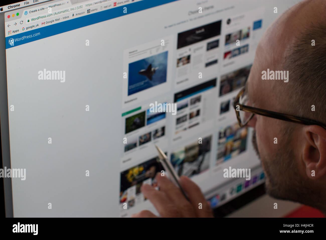 man looking at website of Wordpress Stock Photo - Alamy