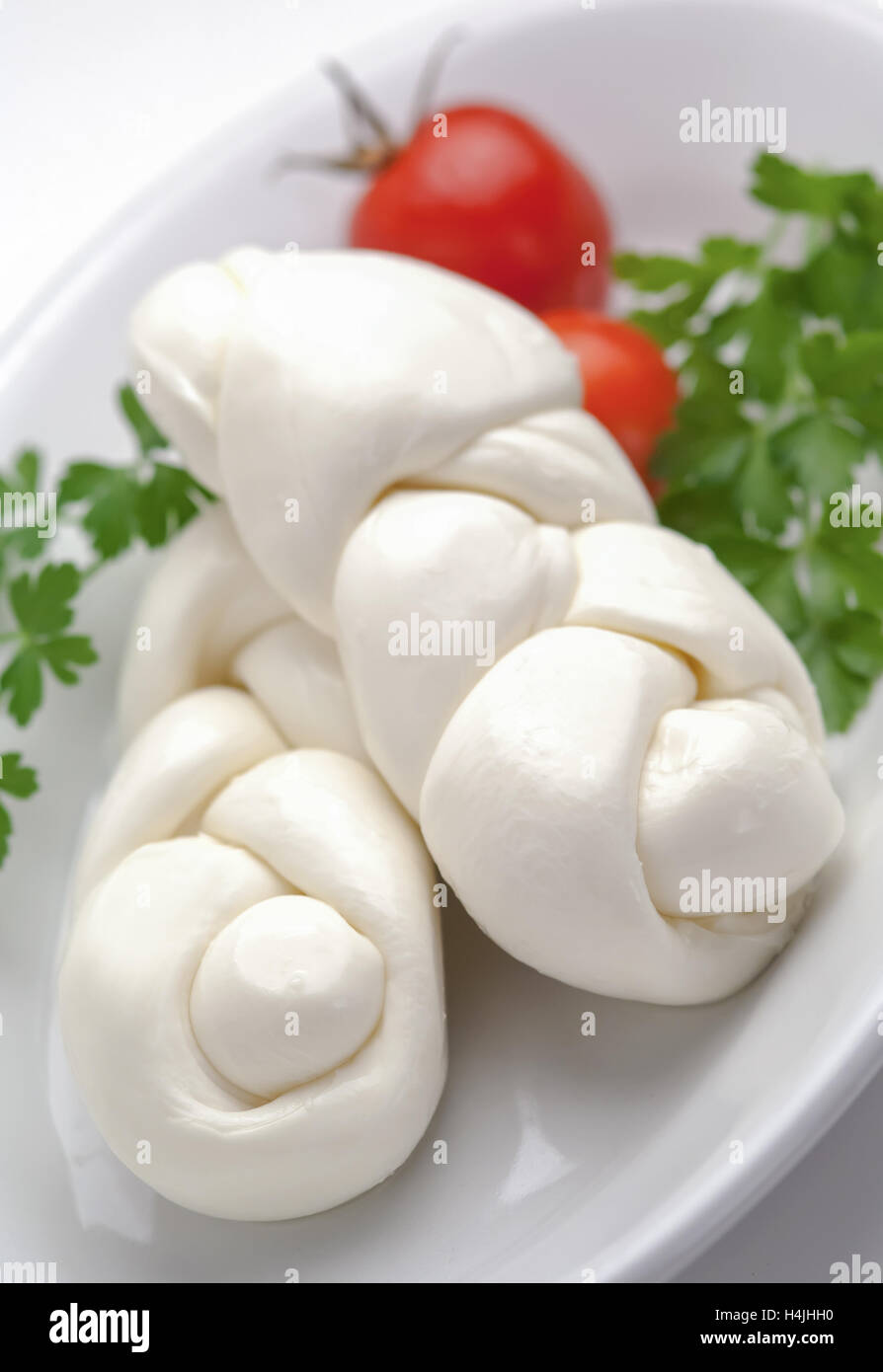 Braid buffalo mozzarella closeup with tomatoes Stock Photo - Alamy