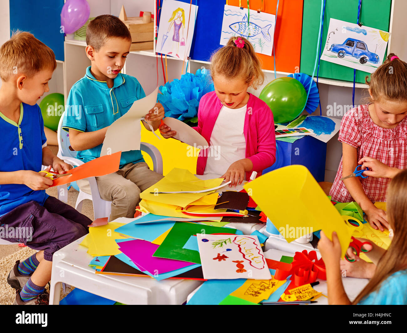 Children make overall project are making something out of paper Stock ...