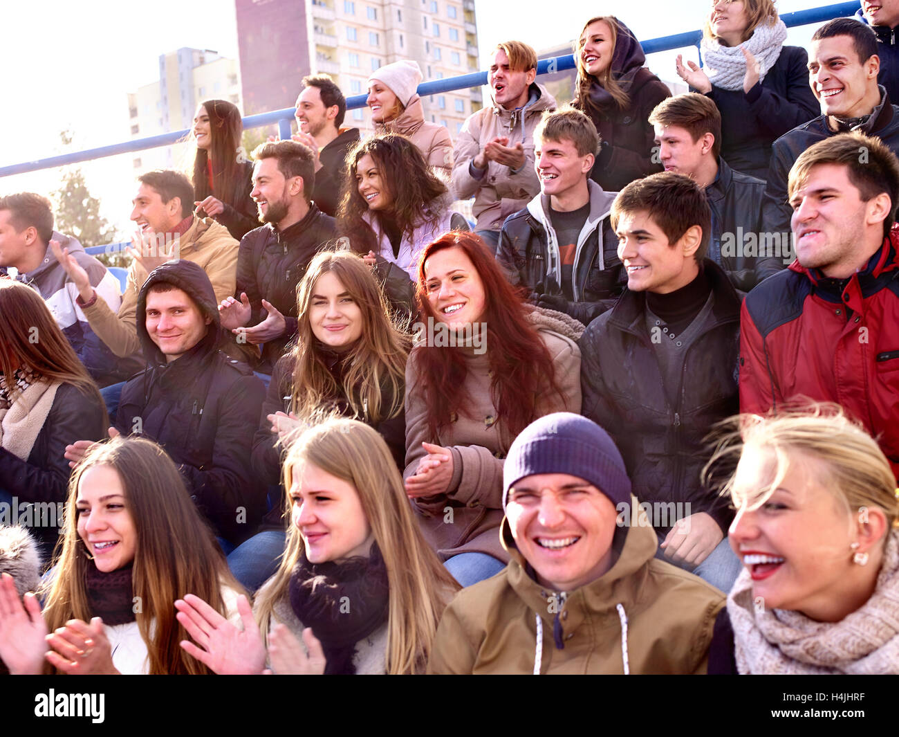 Sport fans clapping and singing on tribunes. Winter weather Stock Photo ...