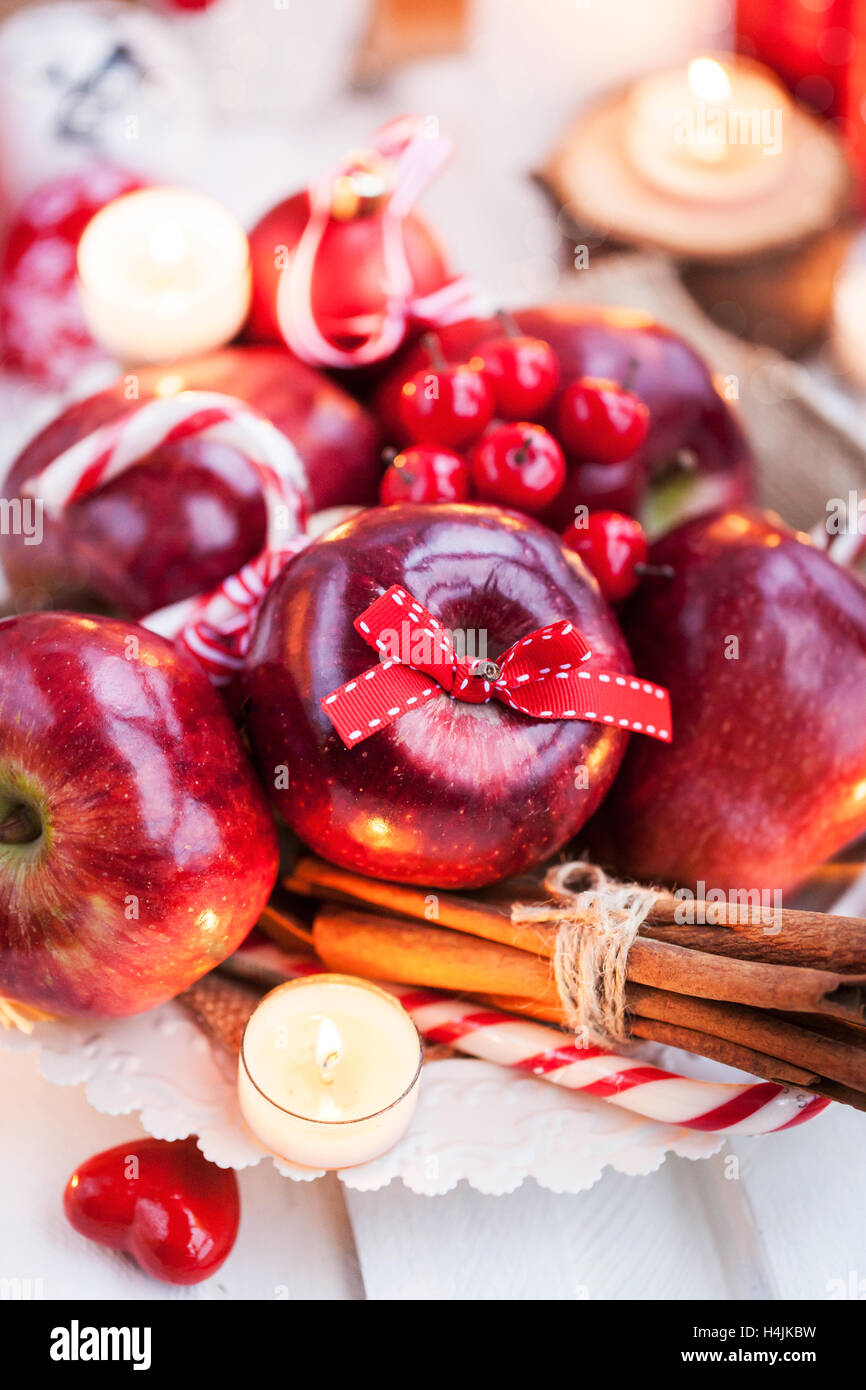 Christmas composition with red apples, cinnamon, toy and candles Stock ...