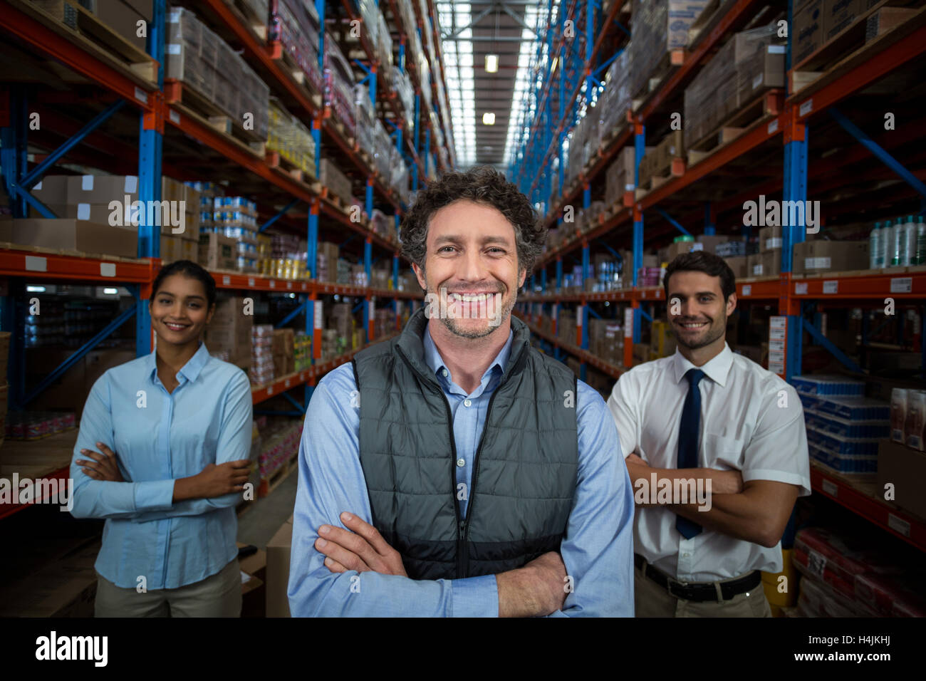 Portrait of warehouse team standing with arms crossed Stock Photo - Alamy