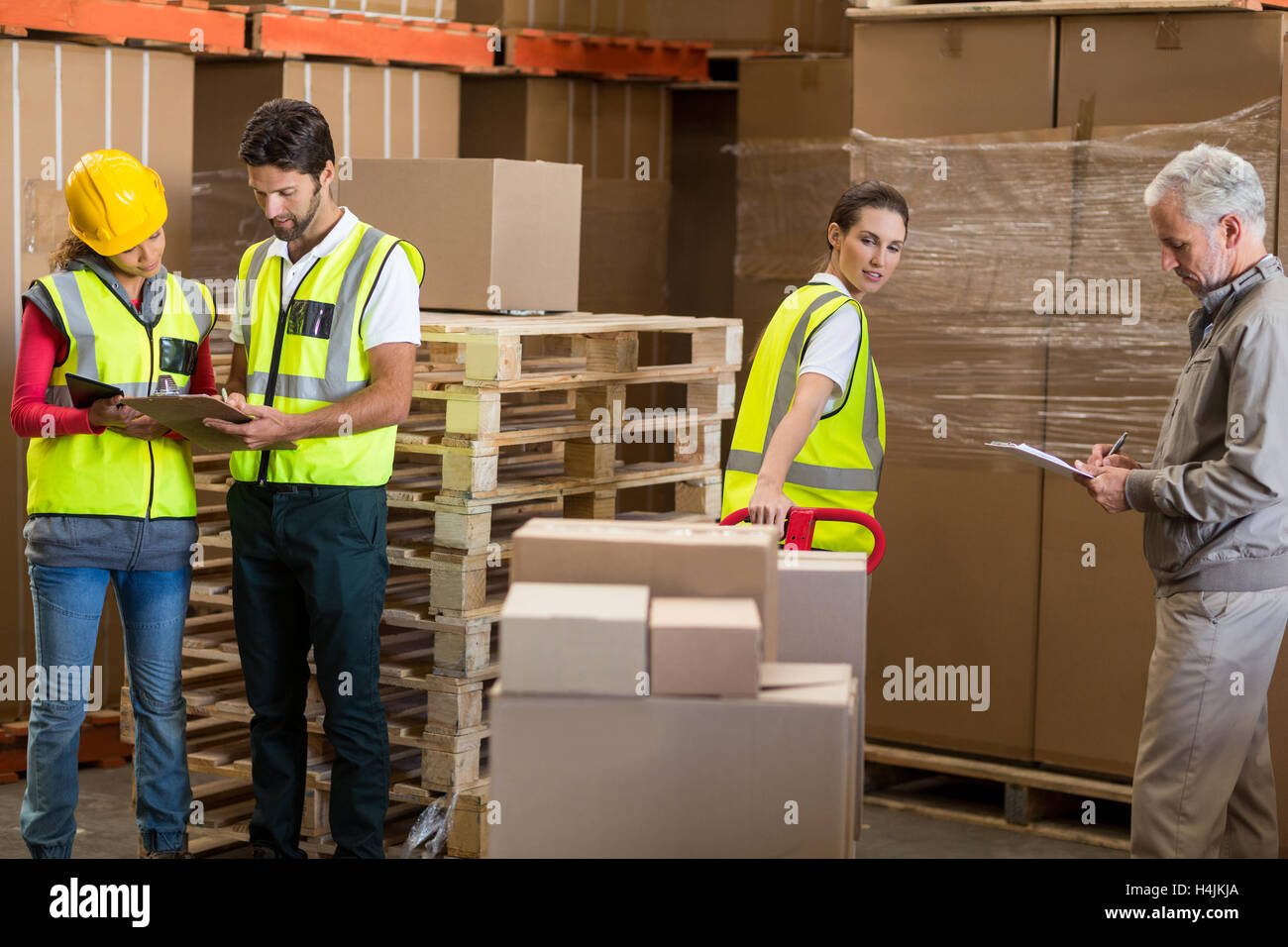 Warehouse manager and workers preparing a shipment Stock Photo - Alamy