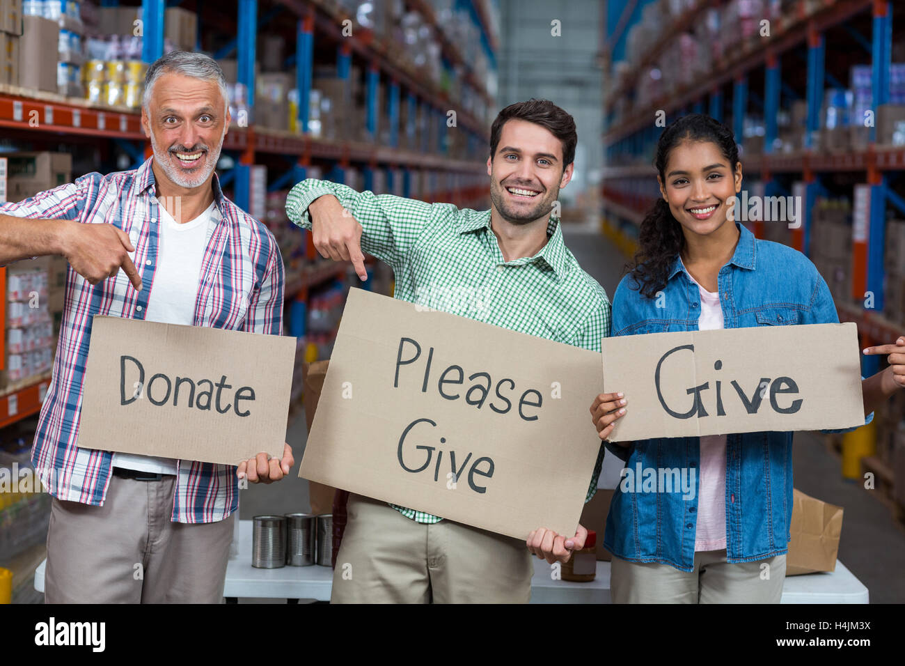 Happy colleagues holding sign boards and looking at messages Stock ...