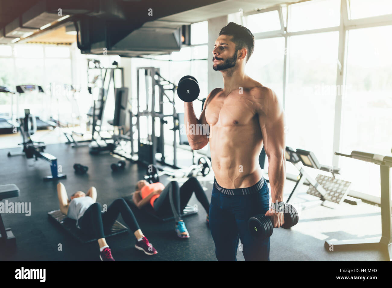 Strong bodybuilder working out in gym Stock Photo - Alamy