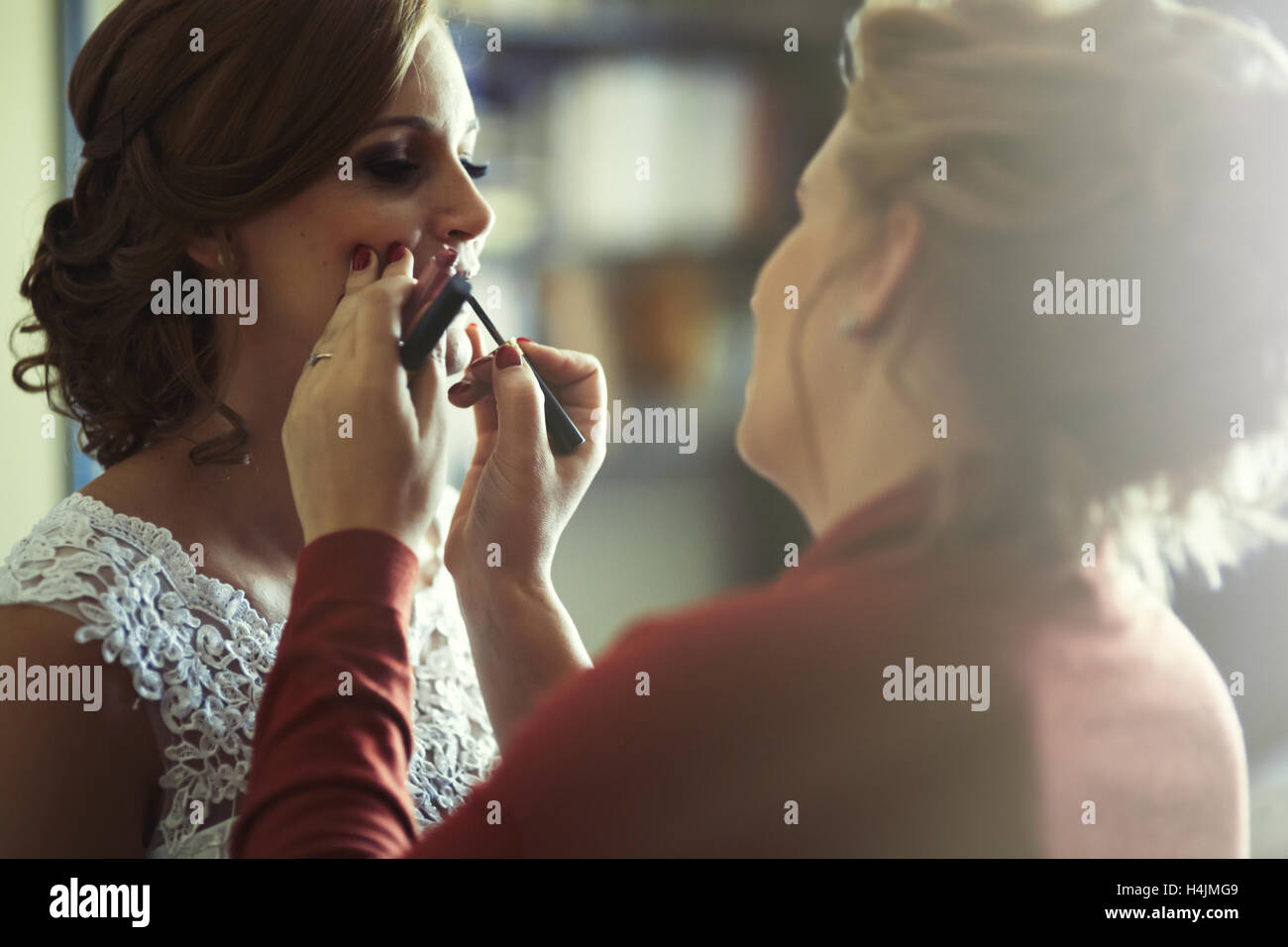 Bride makeup being done by sister at home Stock Photo - Alamy