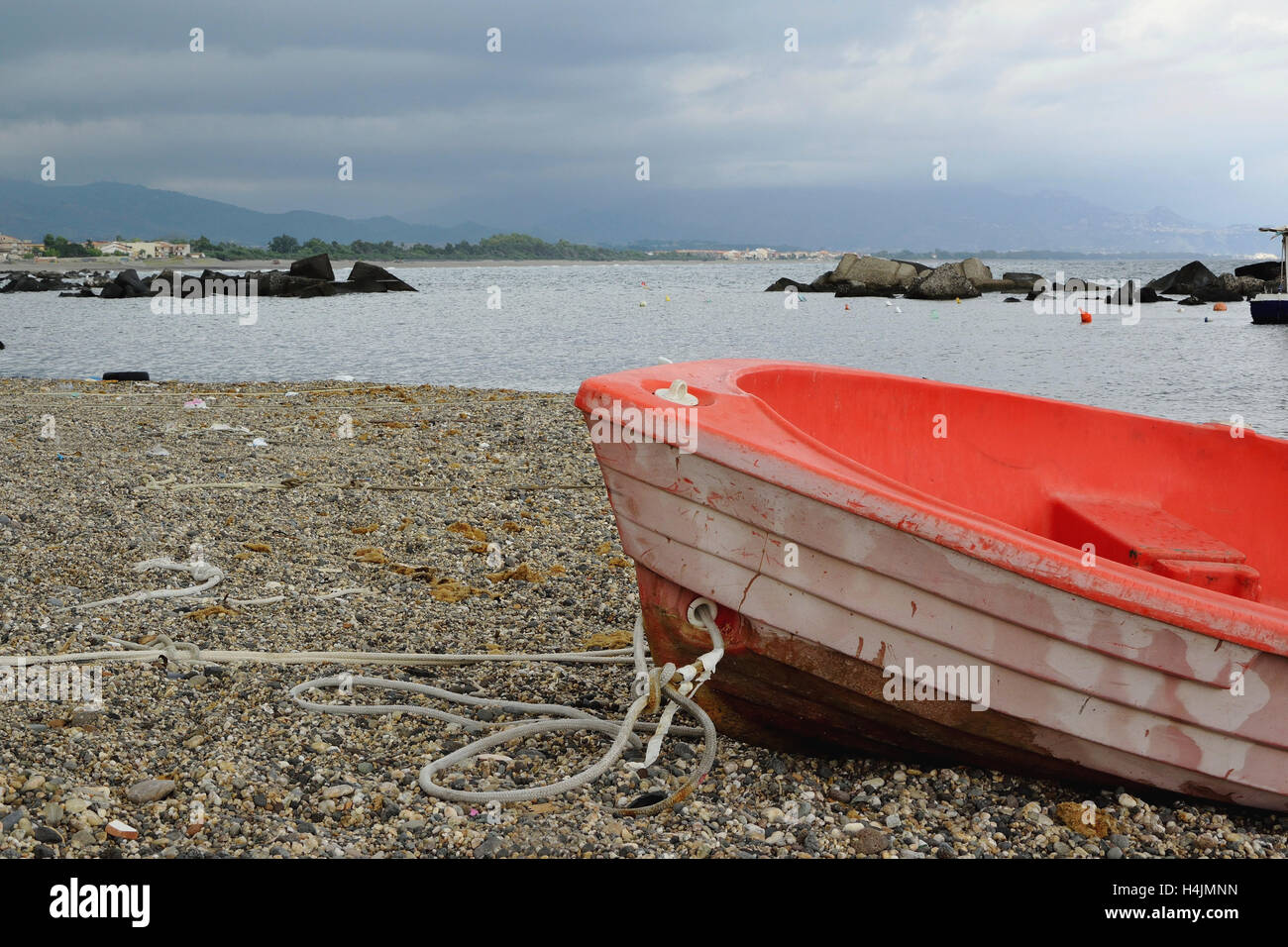 Old red boat on the shore Stock Photo - Alamy