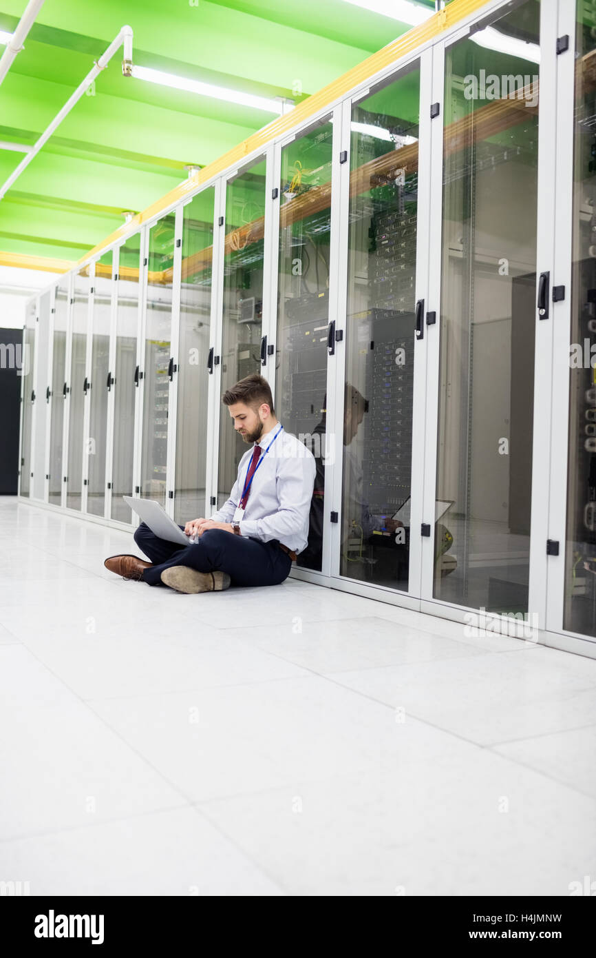 Technician using laptop Stock Photo - Alamy