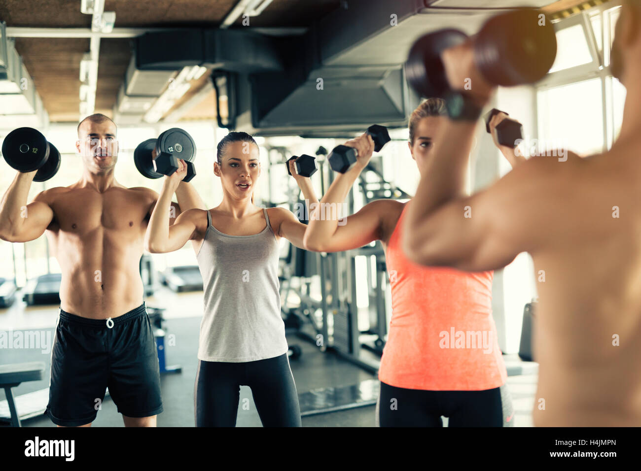 Group friends flexing muscles together hi-res stock photography and ...