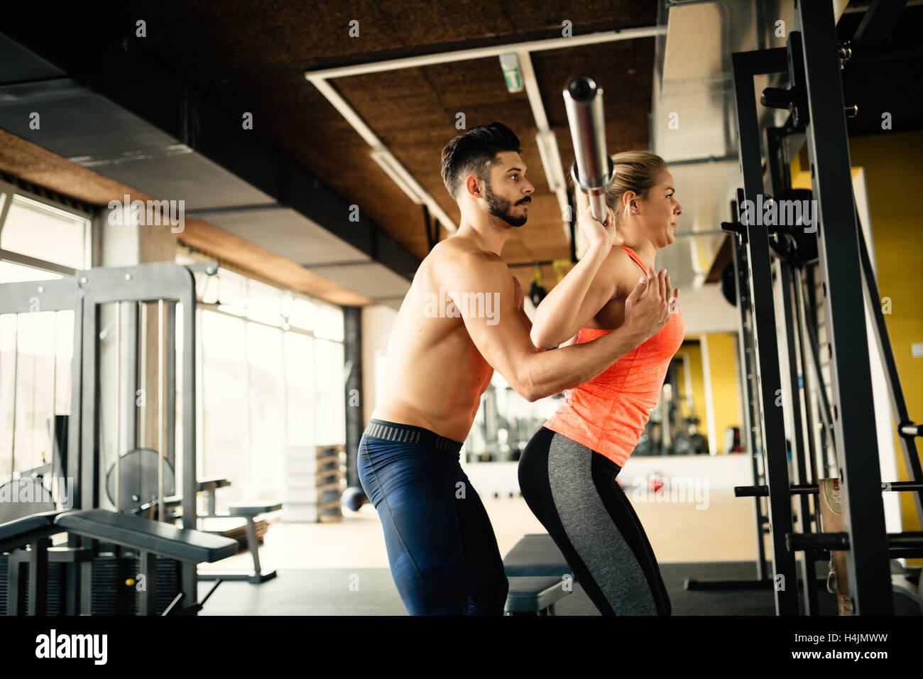 Personal trainer giving instructions to student in gym Stock Photo - Alamy