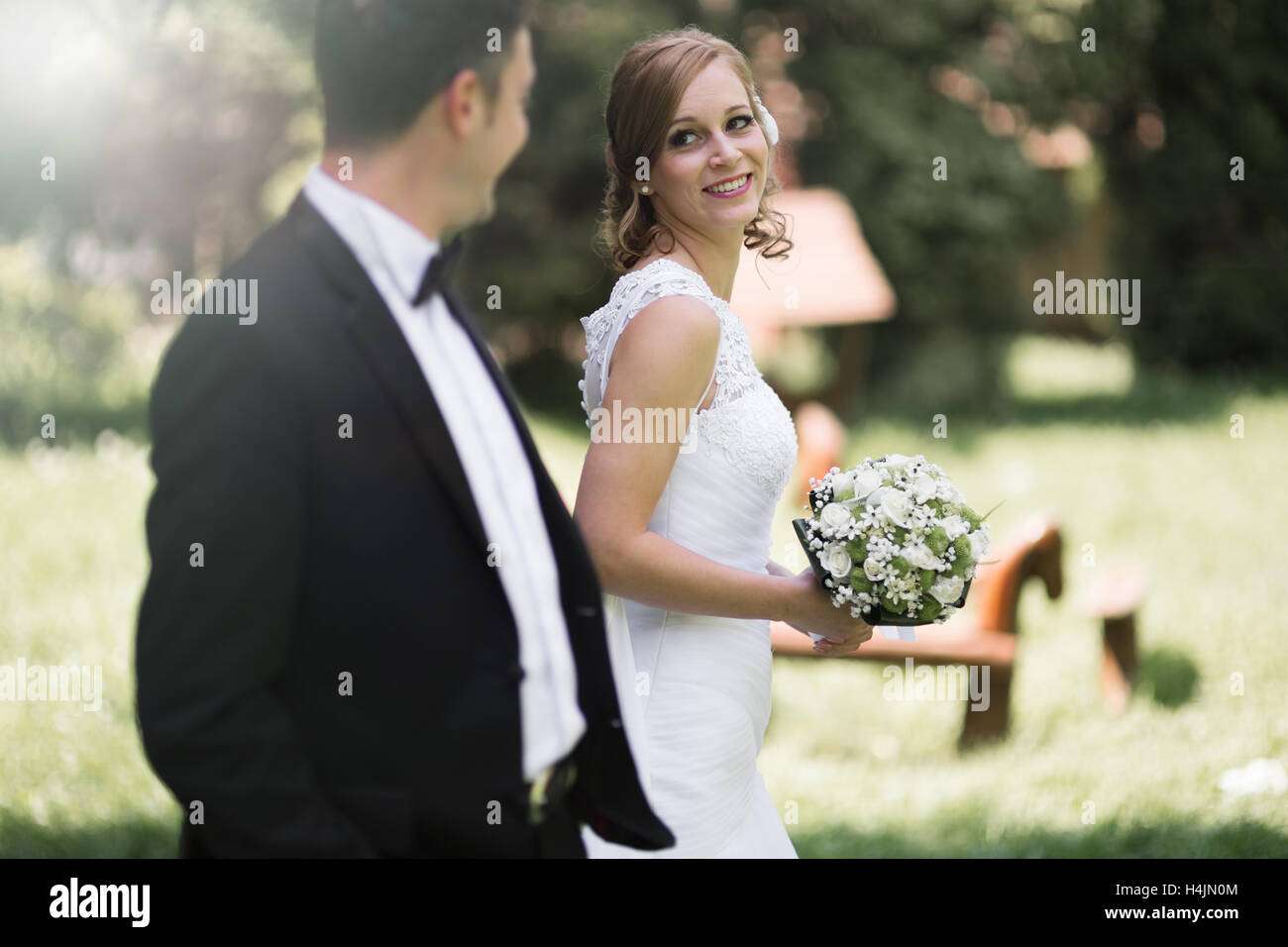 Bride and groom outdoor smiling casually Stock Photo - Alamy