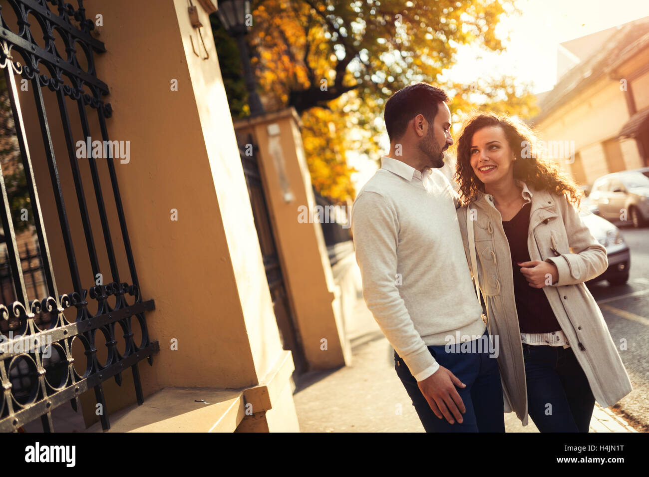 Beautiful couple walking outdoors and hugging in fall Stock Photo - Alamy