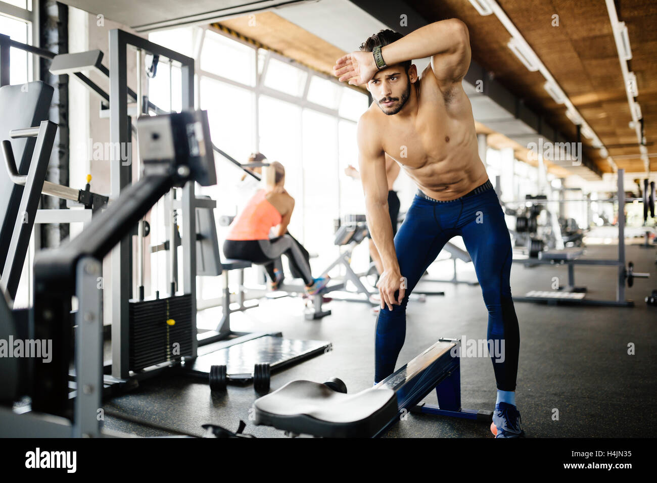 Exhausted athlete working out in gym Stock Photo - Alamy