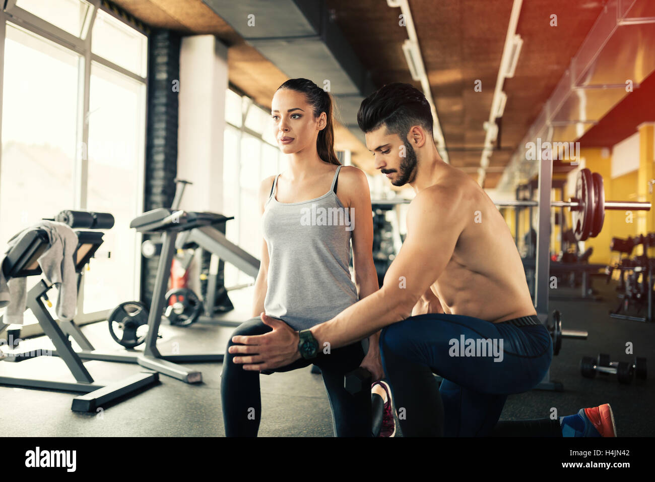 Personal trainer giving instructions to student in gym Stock Photo - Alamy