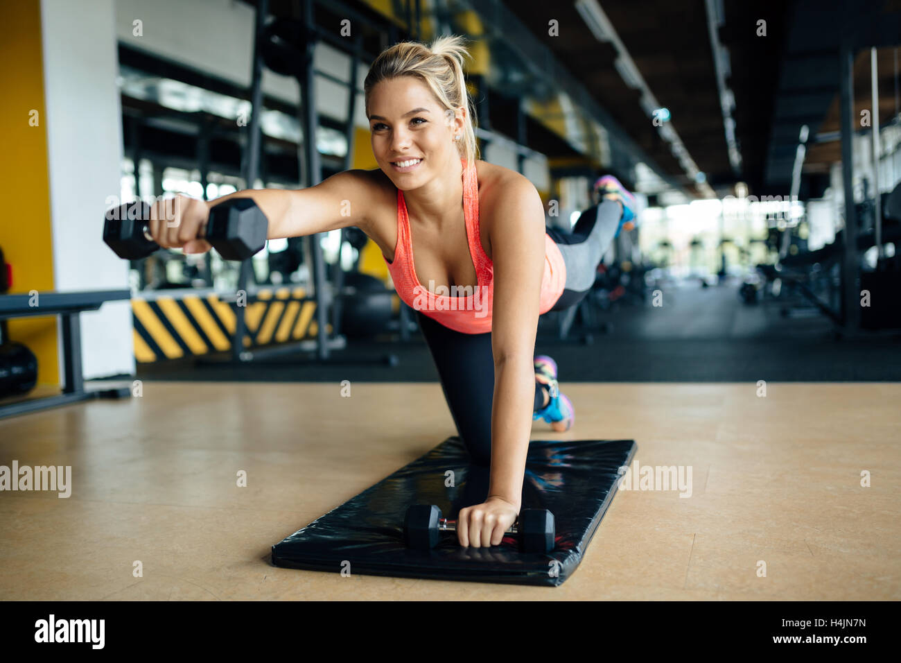 Beautiful woman working out in gym Stock Photo - Alamy