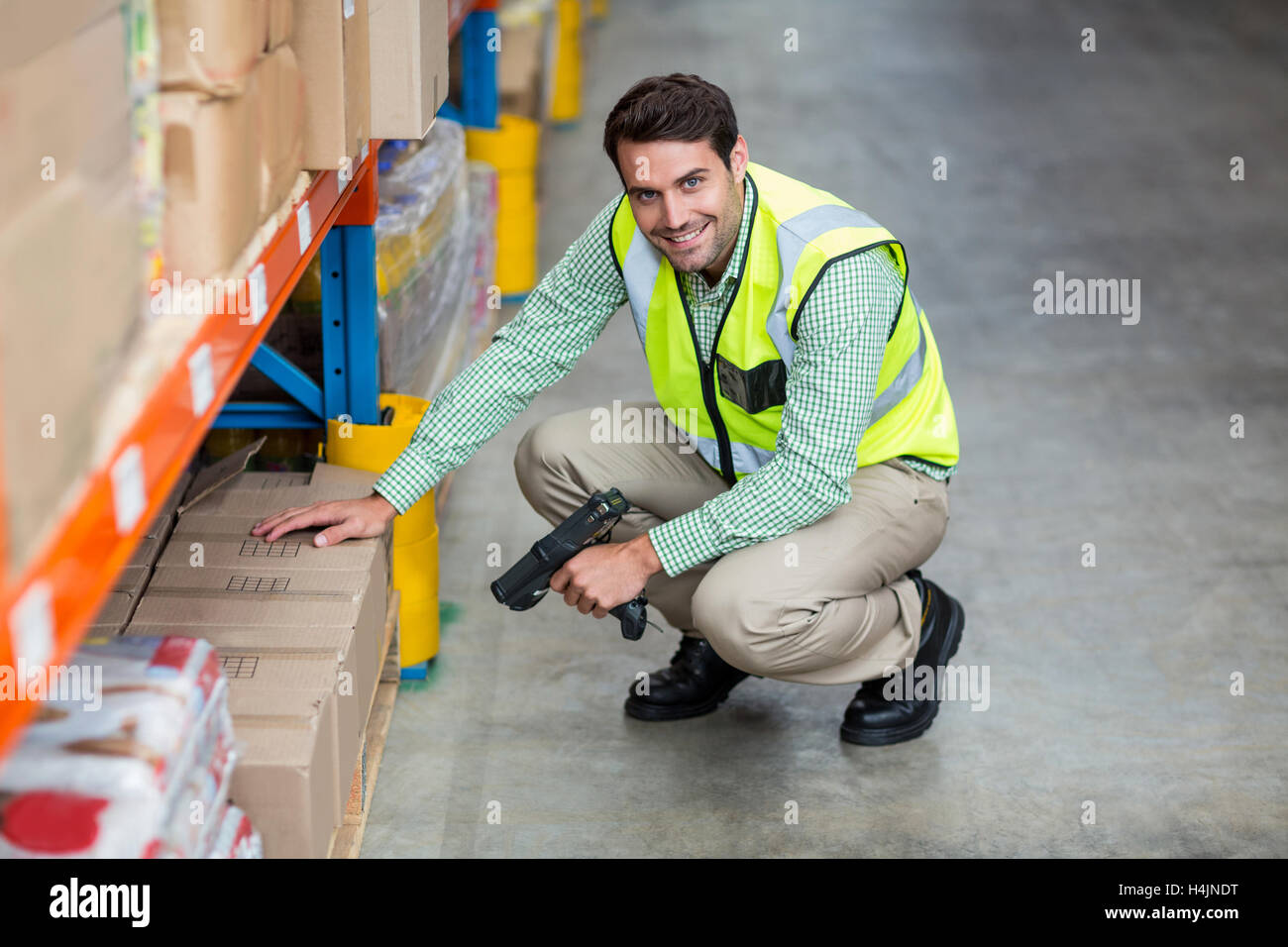 Portrait of smiling warehouse worker scanning box Stock Photo - Alamy Portrait of smiling warehouse worker scanning box Stock Photo - Alamy