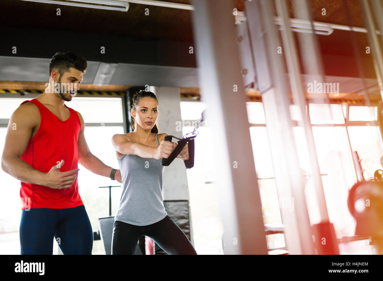 Personal trainer giving instructions to student in gym Stock Photo - Alamy