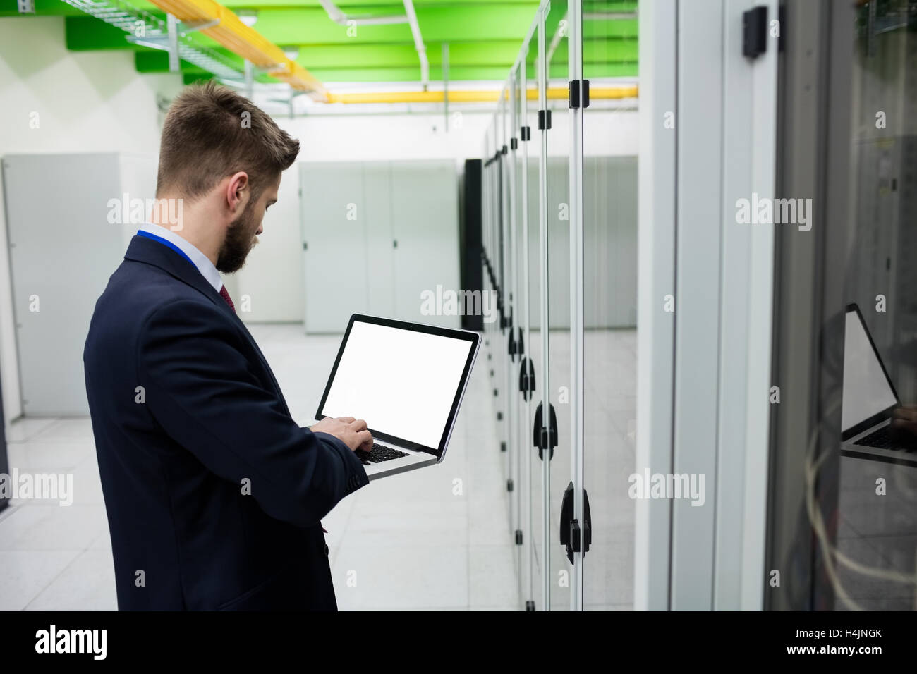 Technician using laptop Stock Photo - Alamy