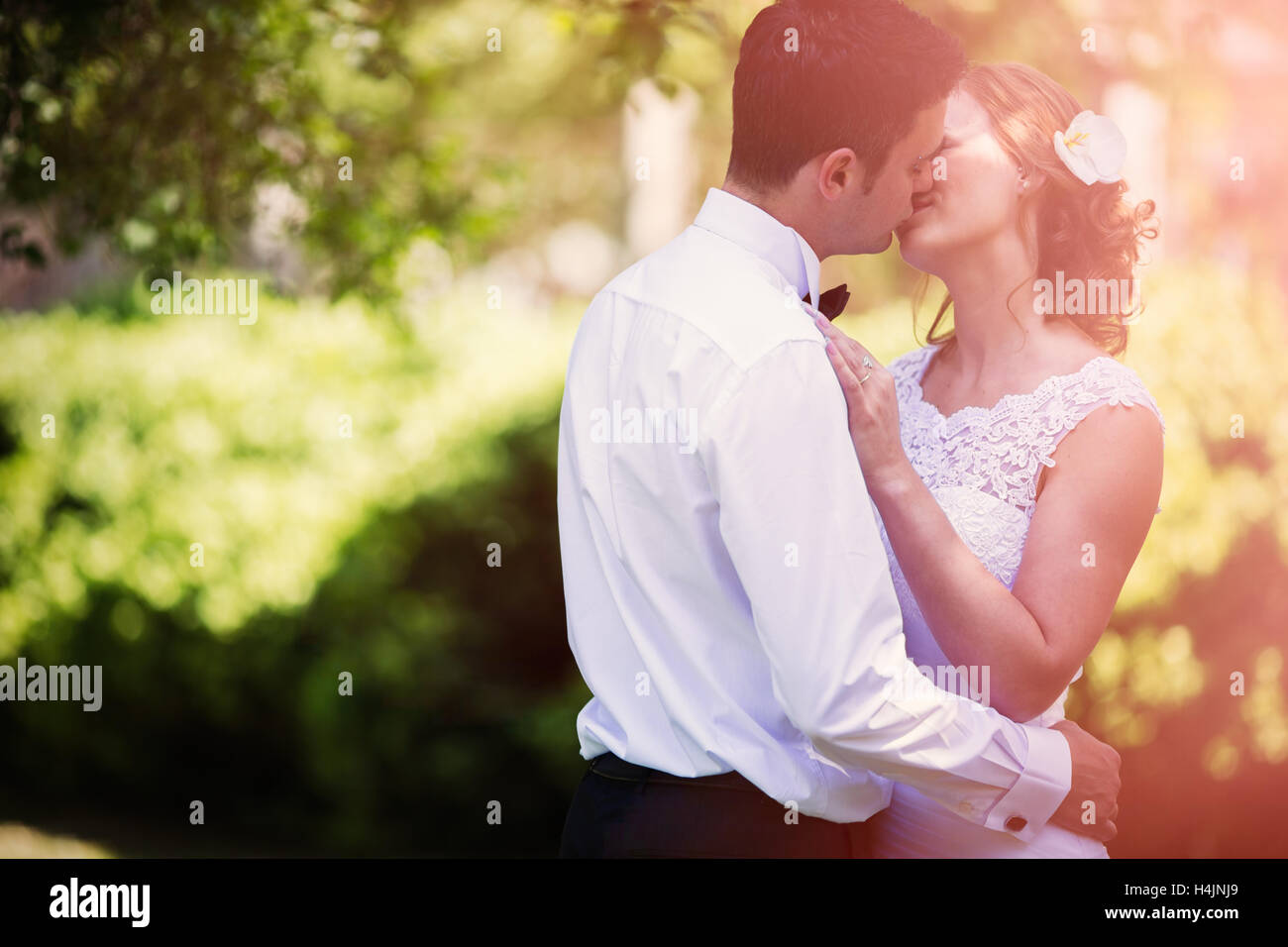 Beautiful bride and groom kissing outdoors after ceremony Stock Photo ...