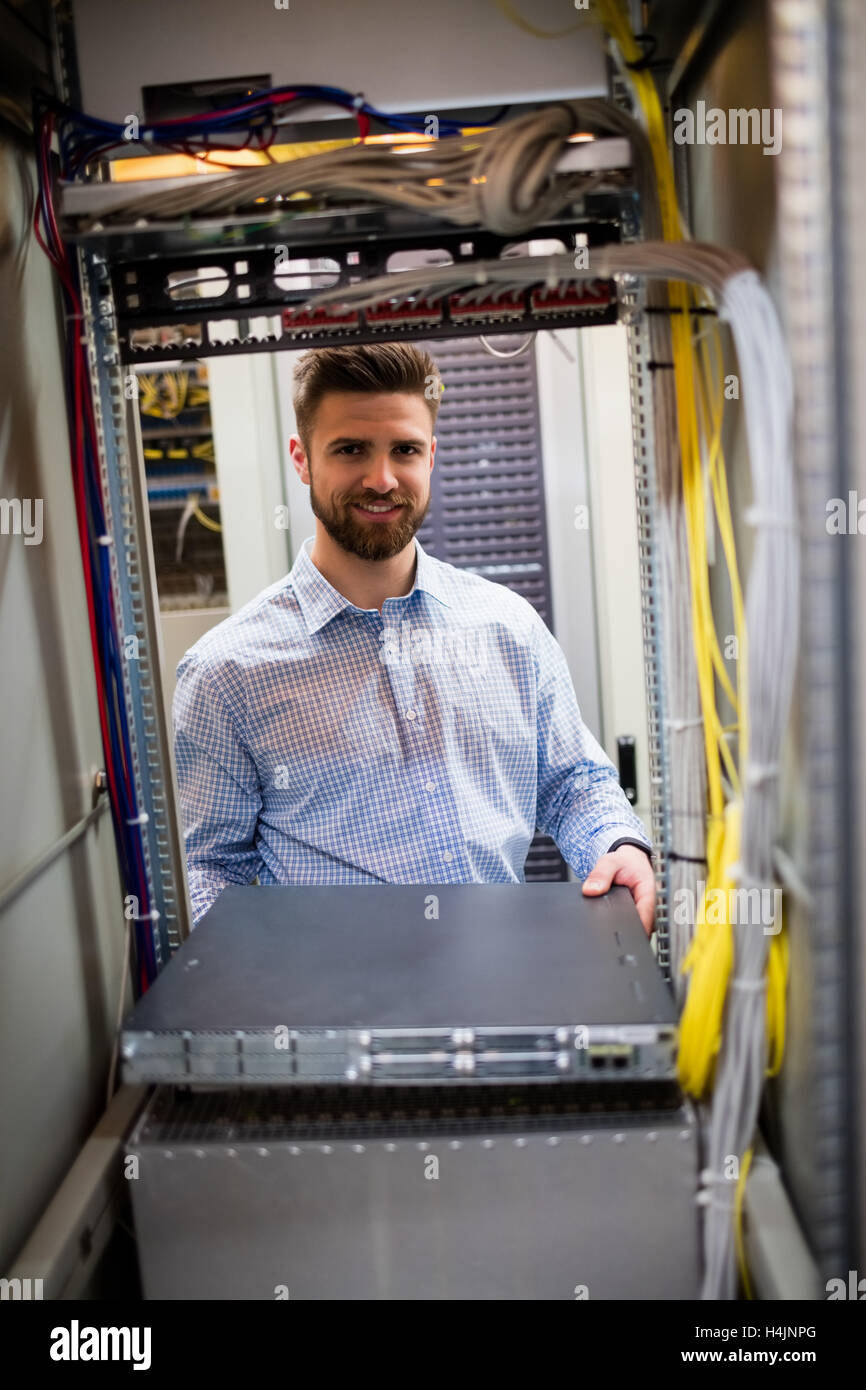 Technician removing server from rack mounted server Stock Photo - Alamy