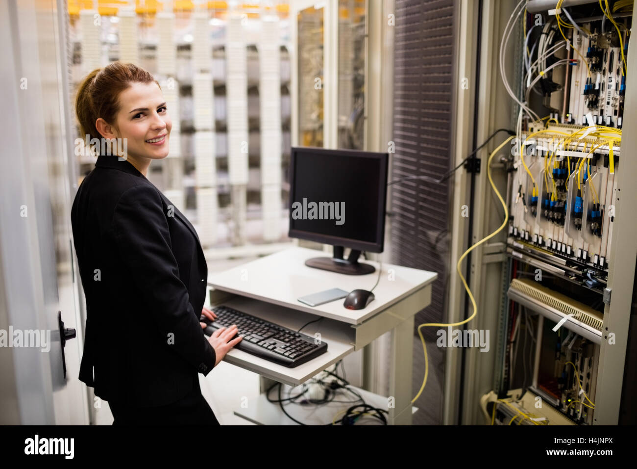Technician working on computer while analyzing server Stock Photo - Alamy Technician working on computer while analyzing server Stock Photo - Alamy