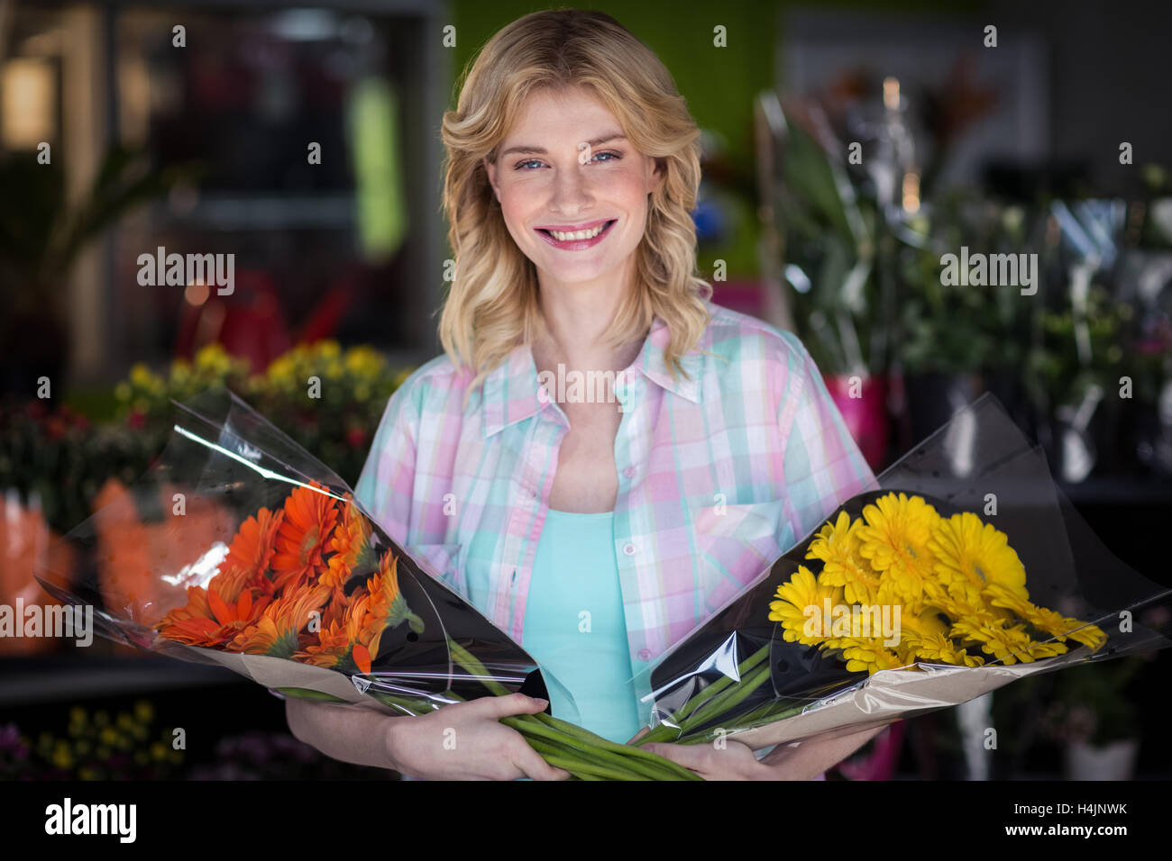 Happy female florist holding flower bouquet Stock Photo - Alamy