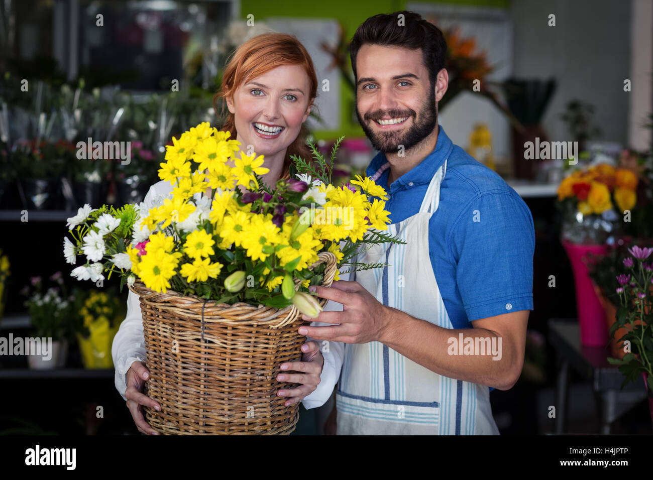 Couple standing with flower basket Stock Photo - Alamy