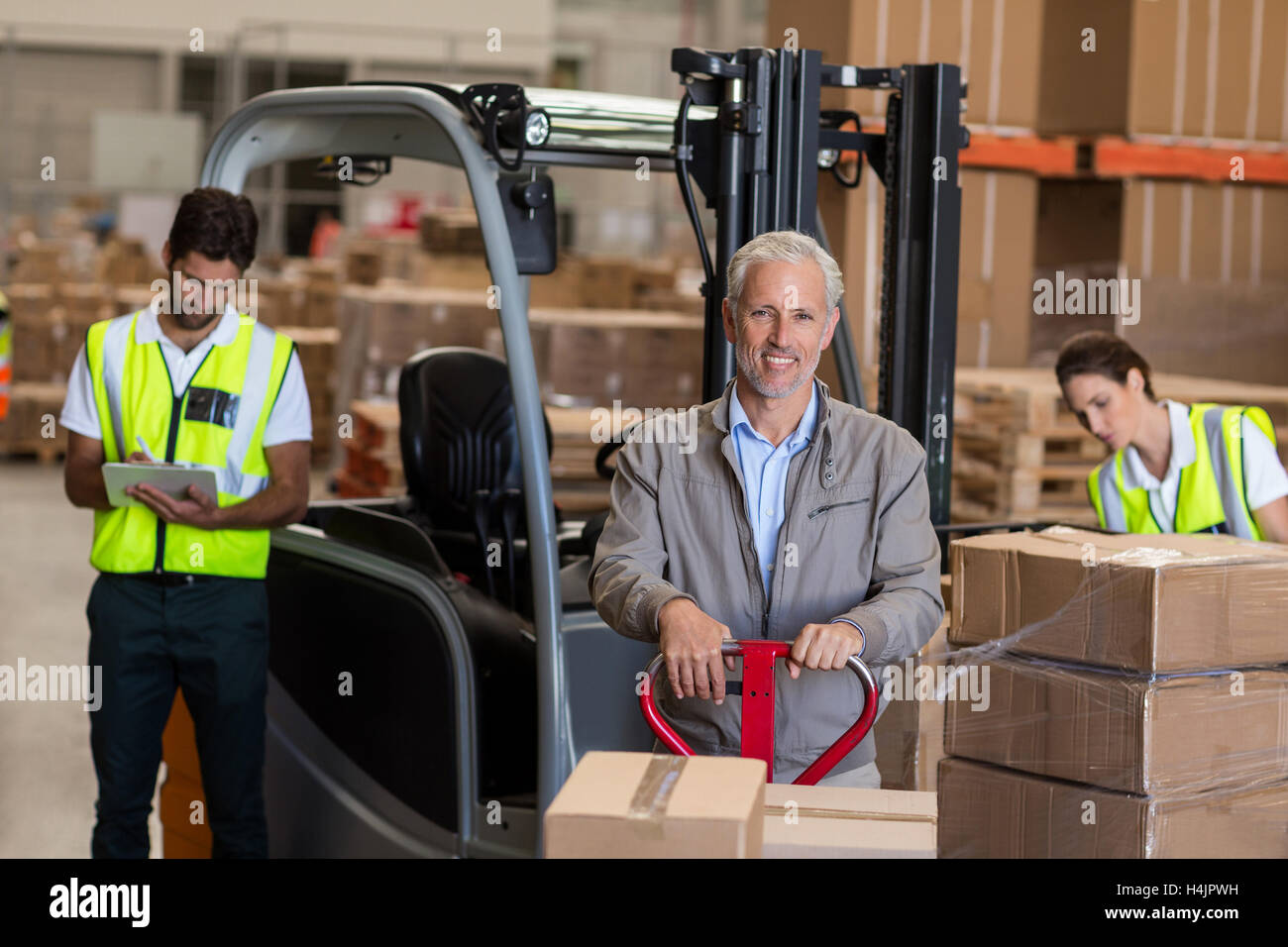 Warehouse manager and workers preparing a shipment Stock Photo - Alamy