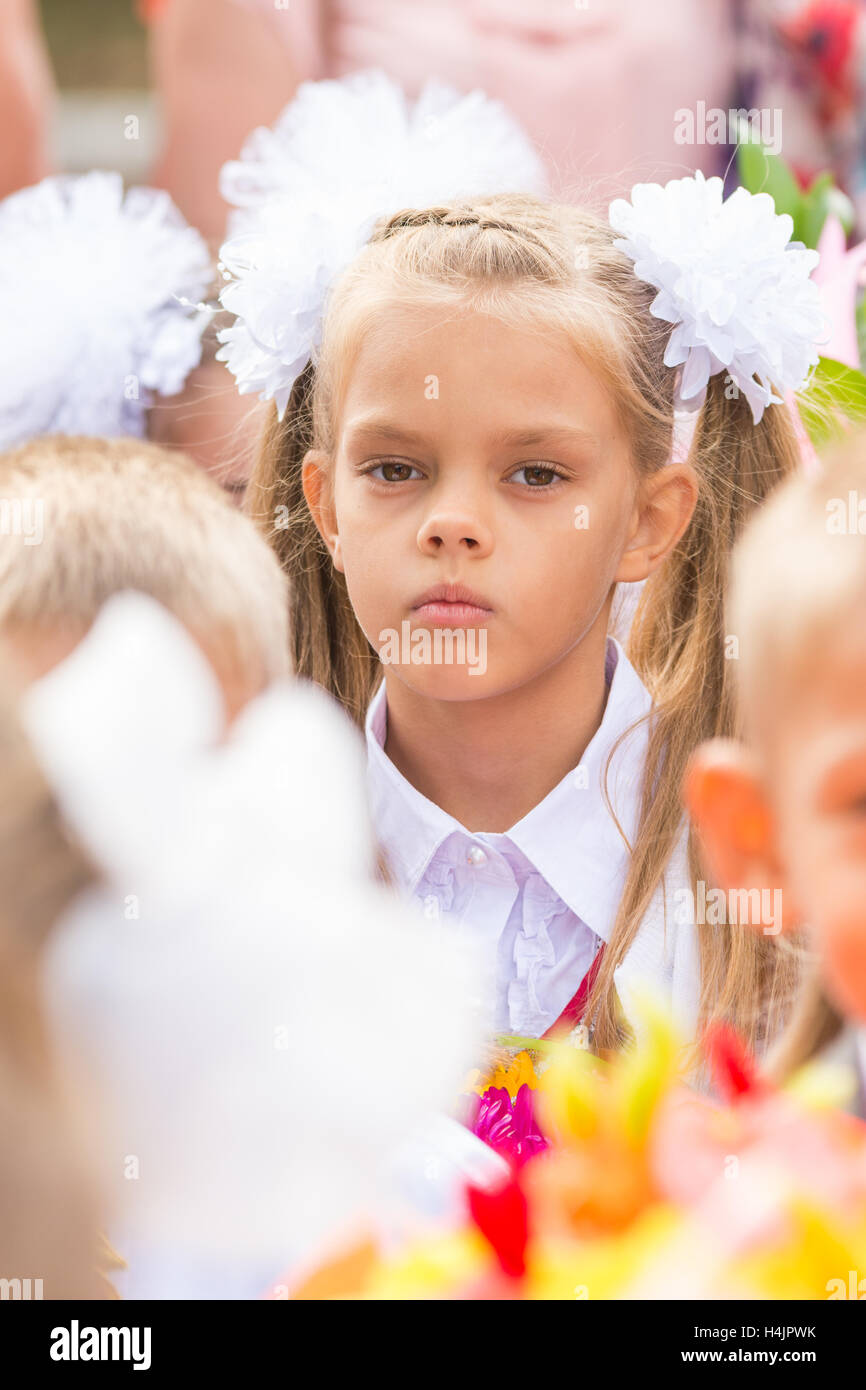 First grader tired of classmates in the crowd at the first line of ...
