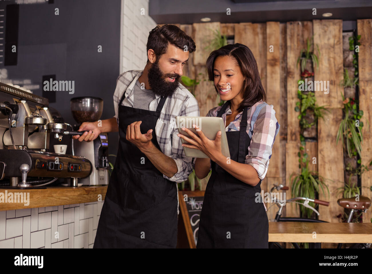Waiter and waitresses using laptop while working Stock Photo - Alamy